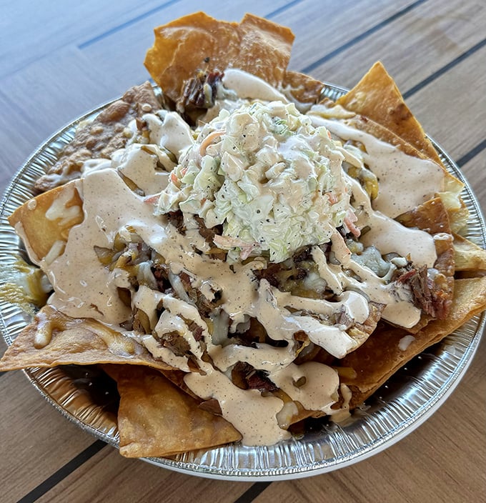 BBQ nachos that break all the rules in the best possible way—crispy tortilla chips loaded with smoky pulled pork, creamy sauce, and tangy slaw for the ultimate indulgence.