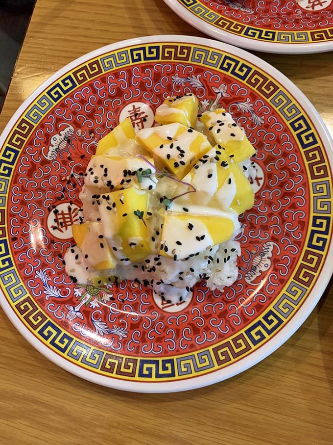 Mango sweet rice sprinkled with black sesame seeds—the dessert that proves fruit and rice can be friends with benefits.