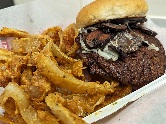 A mushroom burger that proves vegetables and beef can coexist in perfect harmony. Those caramelized onion rings aren't just toppings – they're a flavor revolution.