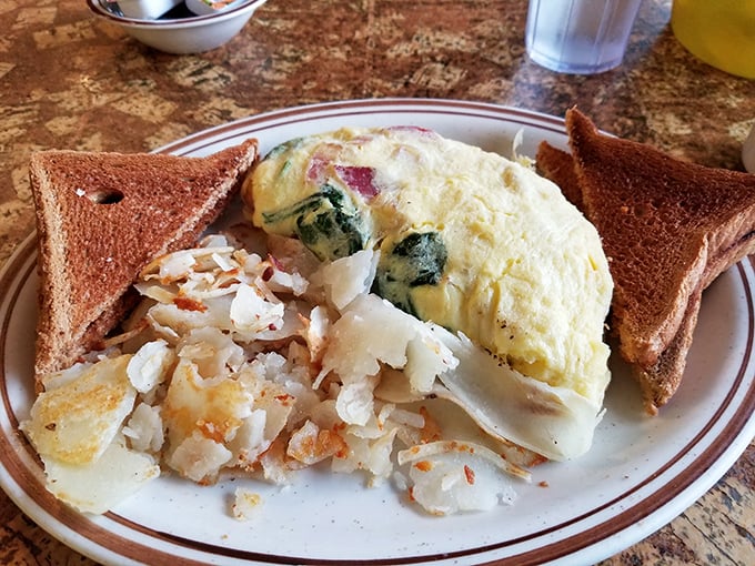 An omelet that's seen the inside of a real kitchen, not a food lab—stuffed with ham and cheese and paired with potatoes that actually came from the ground.
