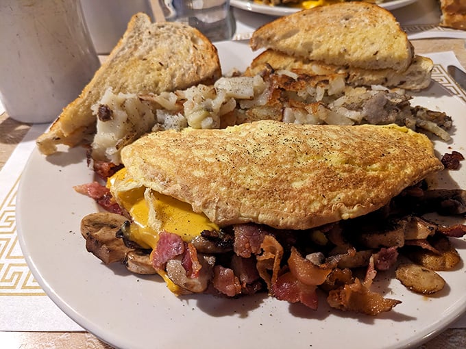 The Western omelet at Fred's doesn't just contain ingredients—it showcases them, with each bite offering a perfect harmony of flavors alongside golden hash browns.