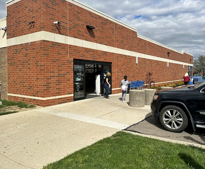 The exterior view shows shoppers eagerly entering their bargain hunting grounds. Like pilgrims arriving at a shrine to secondhand treasures, they come seeking retail revelation.