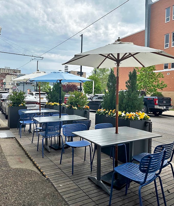 The outdoor dining area offers a breath of fresh air with blue chairs and umbrellas—perfect for people-watching while demolishing your burger.
