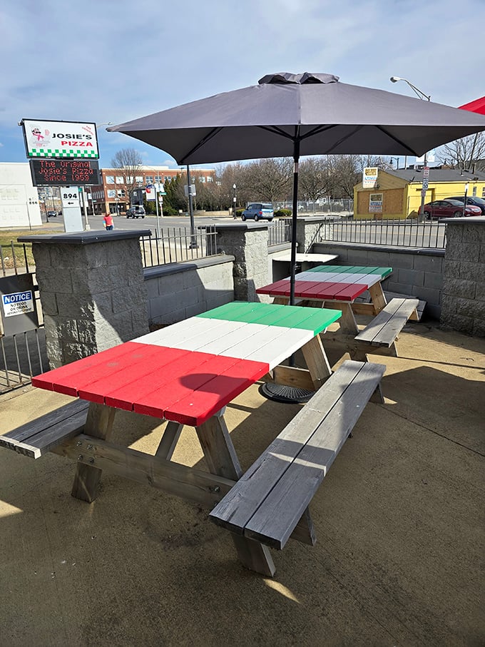 Picnic tables painted in Italian flag colors—subtle patriotism meets practical outdoor dining. Where pizza tastes even better under Ohio's big sky.