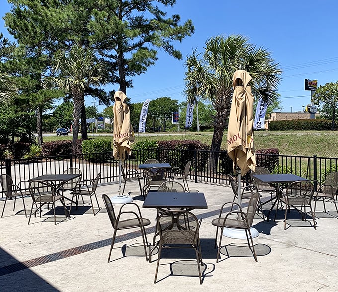 The outdoor patio offers al fresco dining surrounded by palm trees and pines—nature's way of saying "enjoy your breakfast with a side of vitamin D."