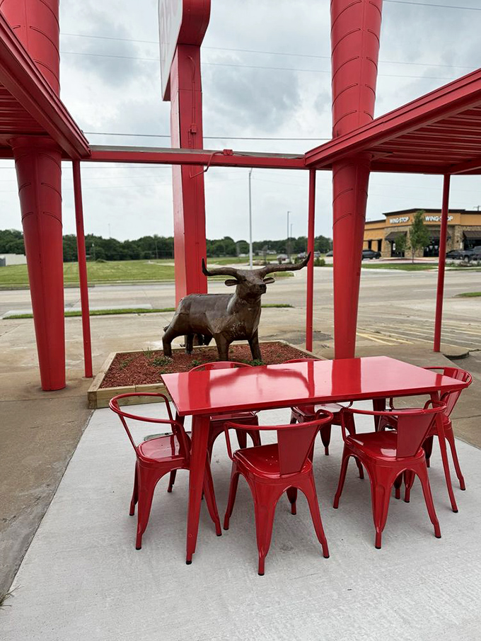Outdoor seating with a longhorn statue means you're dining in proper Texas style, shade included for comfort.
