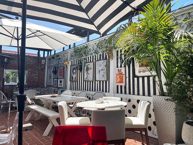 The outdoor patio's striped umbrellas provide shade for leisurely brunches. Art adorns the walls, because at 26 Beach, even the outdoor space tells a story.