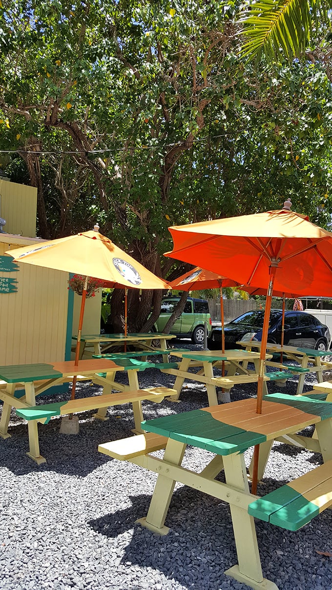 The outdoor seating area—where picnic tables wear yellow and green like they're cheering for a very delicious sports team.