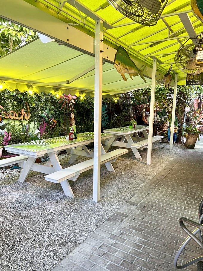The outdoor garden seating area, where palm fronds and string lights create the perfect Florida breakfast theater for your morning performance.