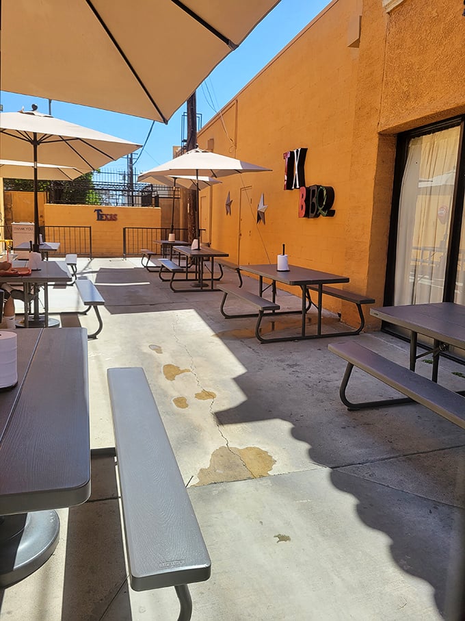 The outdoor seating area: where picnic tables, umbrellas, and the lingering scent of smoke create the perfect stage for your meat-induced happiness.