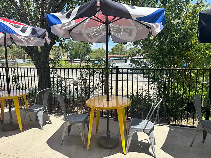 The outdoor seating area – where yellow tables and market umbrellas create the perfect stage for the post-barbecue food coma you've earned.