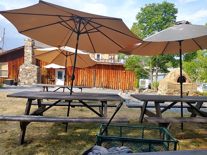 The outdoor seating area offers picnic tables under umbrellas—because pizza this good deserves fresh air and Pennsylvania sunshine.