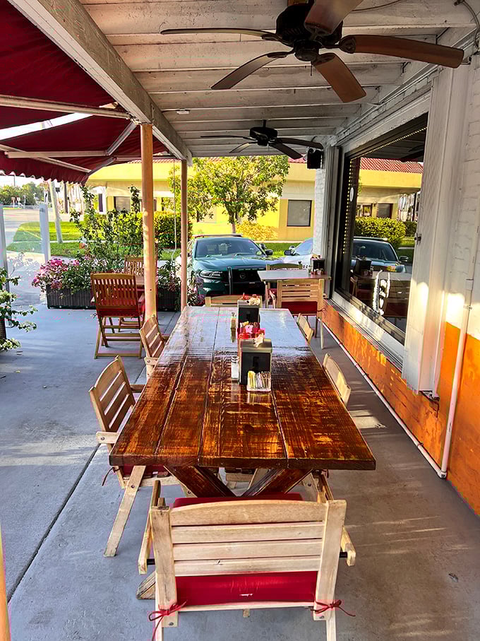 Outdoor seating where Florida sunshine meets French cuisine. Those wooden tables have witnessed countless "mmms" and "you've got to try this" moments.