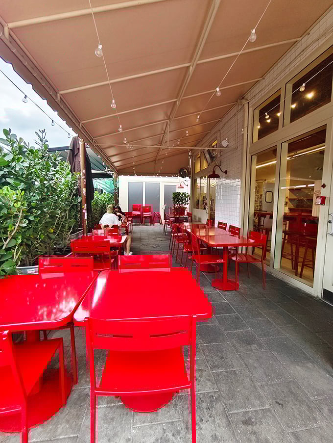 String lights, red tables, and fresh air—the patio setting that elevates your burger experience from meal to memory.