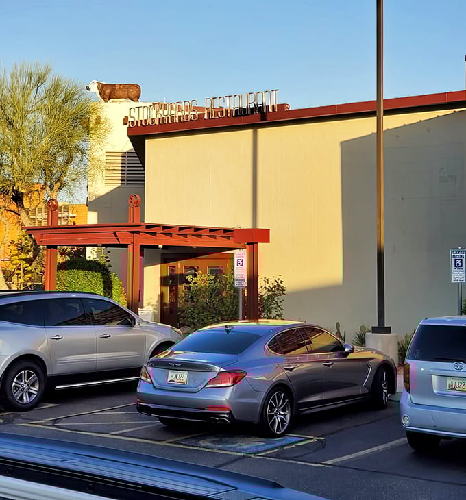 Even from the outside at dusk, The Stockyards promises an evening of culinary delight—that cow on the roof has been watching over happy diners for decades.