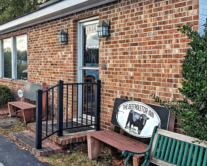 The modest entrance and weathered benches tell you everything: this place puts all its energy into what's on your plate, not what's on its facade.