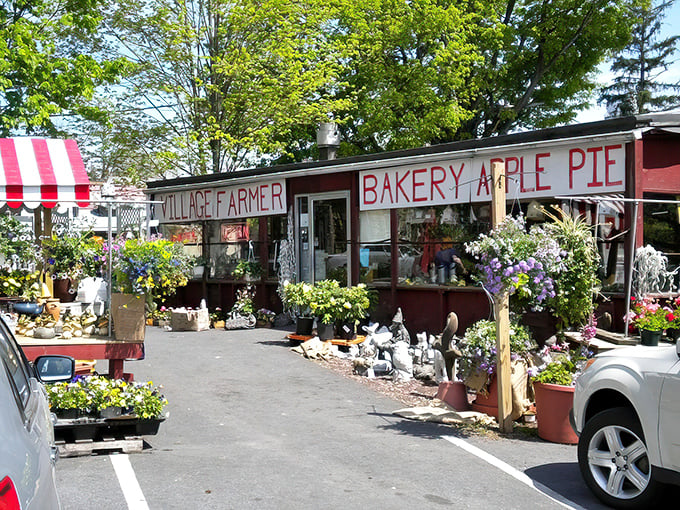 Spring blooms frame the rustic charm of this roadside gem. The "BAKERY APPLE PIE" sign isn't just advertising—it's a promise of deliciousness within.