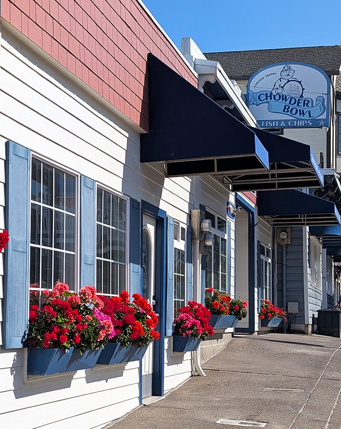 Red geraniums pop against blue shutters and white siding—it's like the restaurant dressed up in nautical colors just for your arrival.f