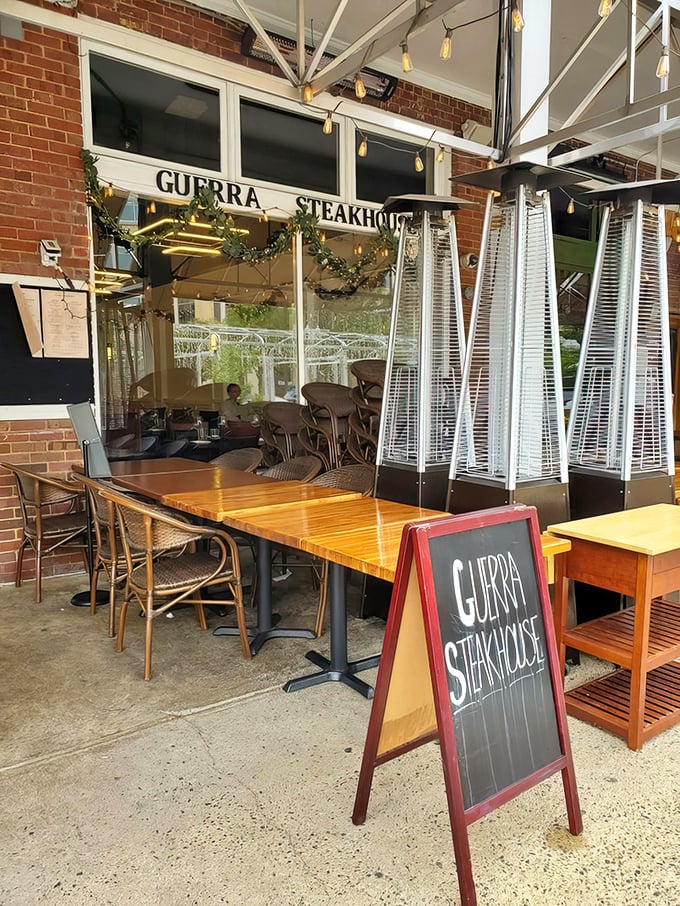 A simple chalkboard sign and wooden tables mark the entrance to culinary excellence—no flashy gimmicks needed when the food speaks for itself.