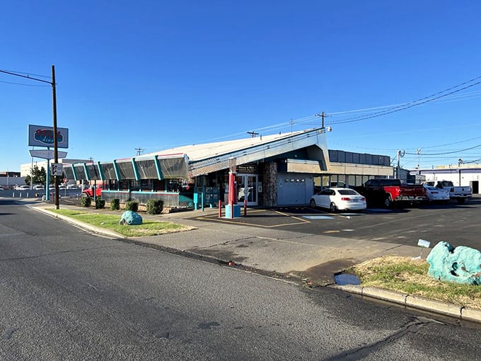 The distinctive silhouette of Mel's Diner against a blue Yakima sky – a landmark that's been filling bellies and creating memories for generations.