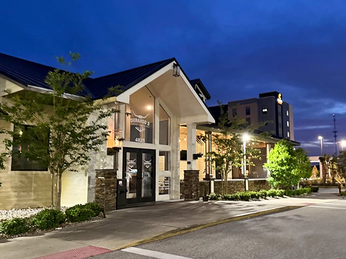 Evening lighting transforms the exterior into an inviting beacon for hungry diners seeking their next great steak experience.