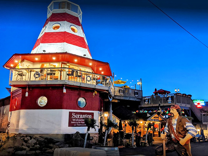 As twilight falls, the lighthouse glows like a maritime fantasy, beckoning seafood lovers from miles around.