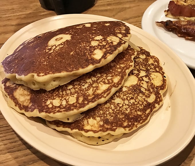 These golden pancakes aren't just breakfast; they're edible sunshine stacked three high—fluffy enough to make clouds jealous.