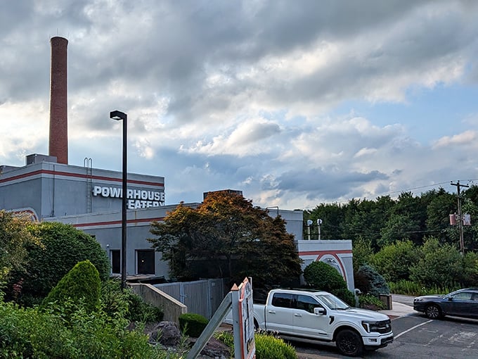 The dramatic sky frames this repurposed power plant perfectly—a structure that once energized a community now fuels memorable dining experiences instead.