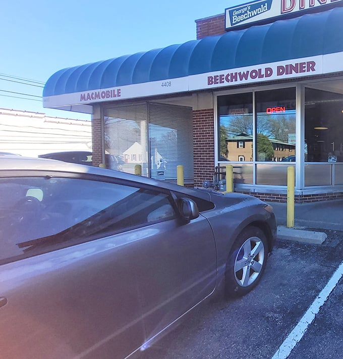Morning sunshine illuminating that signature blue awning – nature's spotlight on a place that understands breakfast isn't just a meal, it's a religion.