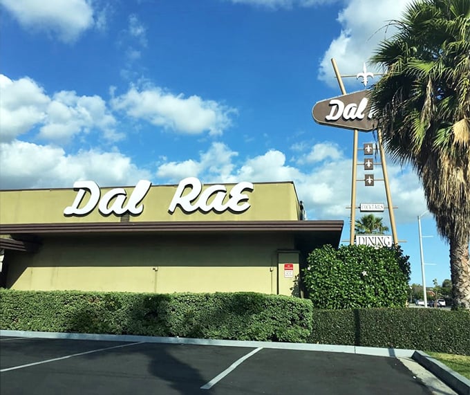 Palm trees frame the Dal Rae's distinctive signage, a California landmark that promises the comfort of tradition in a state obsessed with the next big thing.