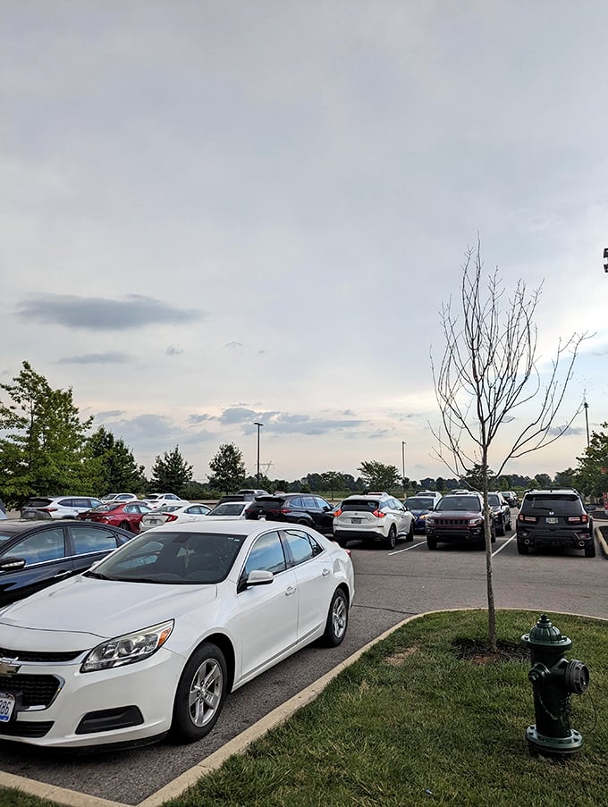 The packed parking lot at dusk tells the true story – Tanger isn't just shopping, it's a destination. Even the fire hydrant looks fashionable here.