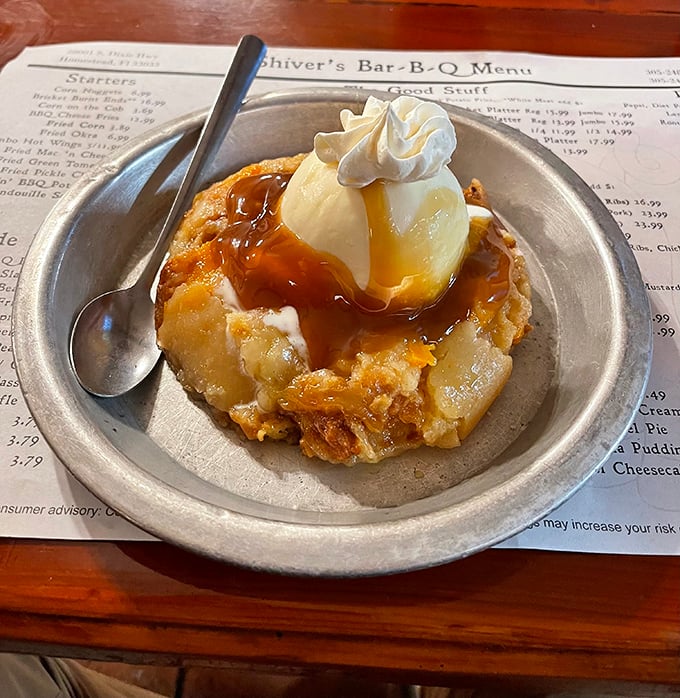 This isn't just peach cobbler—it's warm Southern comfort with a scoop of vanilla ice cream performing its sacred duty of melting into every nook and cranny.