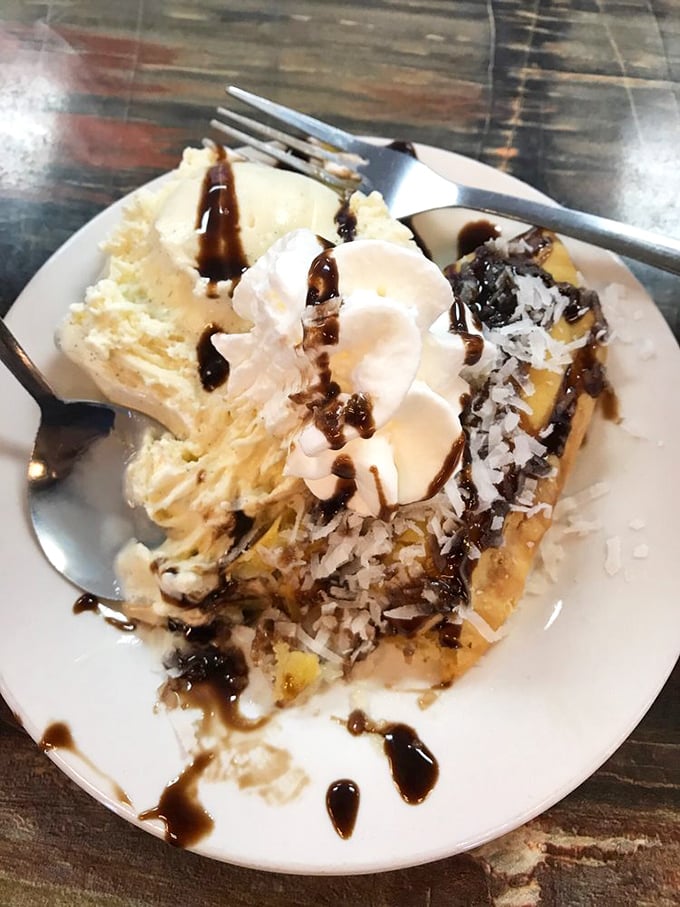 This isn't just dessert—it's a slice of coconut pie that makes time stand still, with whipped cream melting into warm chocolate drizzle.