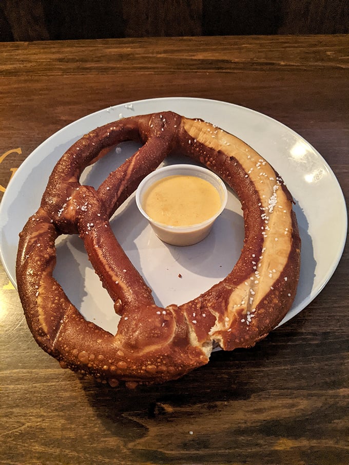 The pretzel that ate Pittsburgh—a glorious carb halo with cheese sauce in the middle, like a doughy solar eclipse on a plate.