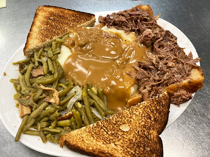 This isn't just a plate—it's a Southern symphony. Pulled pork, green beans, mashed potatoes under gravy, and toast standing by for cleanup duty.