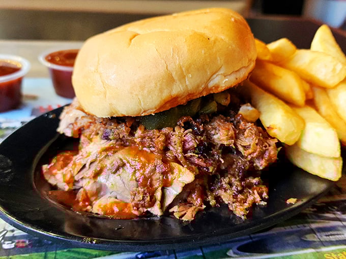 The pulled pork sandwich doesn't just sit on the plate—it commands it, with meat so tender it surrendered to smoke hours ago, flanked by golden fries.