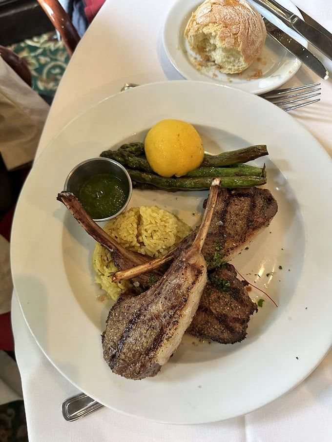 Rack of lamb cooked to pink perfection, served with asparagus and rice pilaf—a dish that proves some classics deserve their permanent place in the culinary pantheon.
