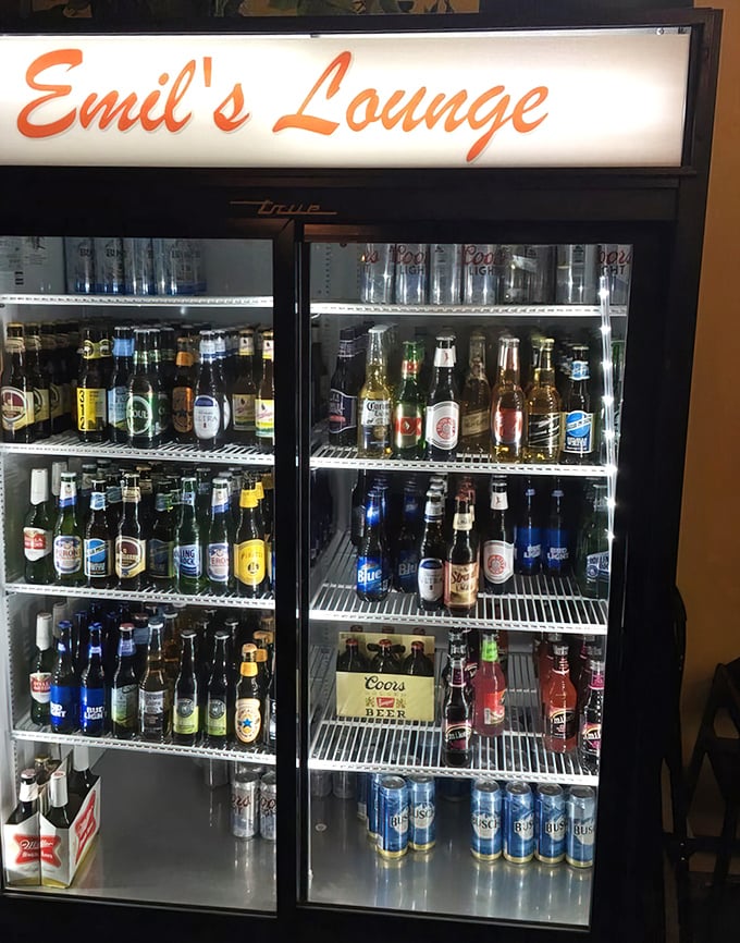 The beer fridge—a cold, glowing beacon of hope for thirsty diners. A democratic display where craft brews and old standbys coexist peacefully.