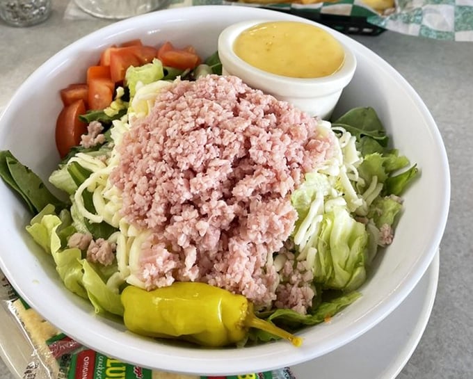 The chef salad offers a lighter option without sacrificing satisfaction—a mountain of ham atop crisp greens with that signature house dressing.
