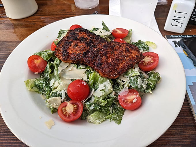 Blackened salmon that could convert a vegetarian. Perfectly seasoned, flaky fish atop a crisp Caesar salad – proof that healthy can be indulgent too.