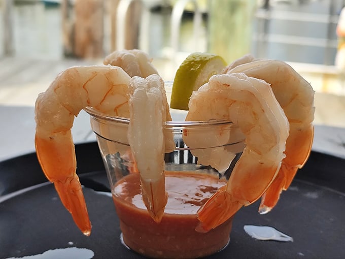 Shrimp cocktail simplicity – plump, perfectly cooked crustaceans perched on a glass, ready for their tangy sauce bath. Ocean candy at its finest!