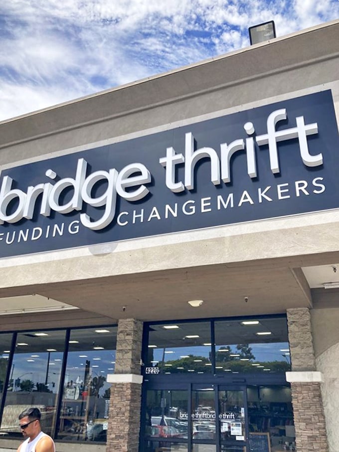 The Bridge Thrift sign stands as a beacon for bargain hunters, promising not just deals but the chance to be part of something bigger than shopping.