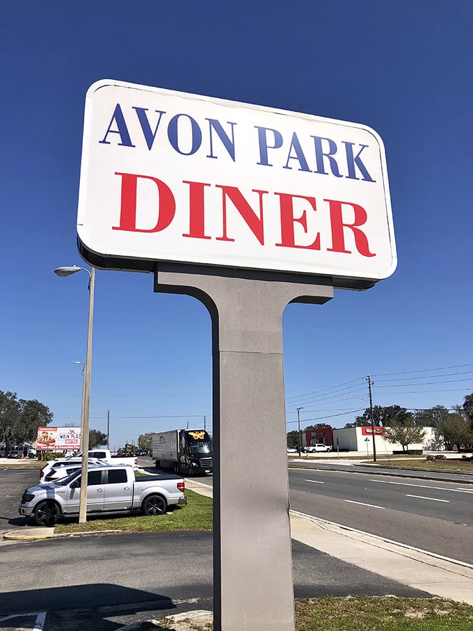 The sign stands tall against the cloudless blue—a North Star for breakfast pilgrims seeking fluffy pancakes and bottomless coffee.