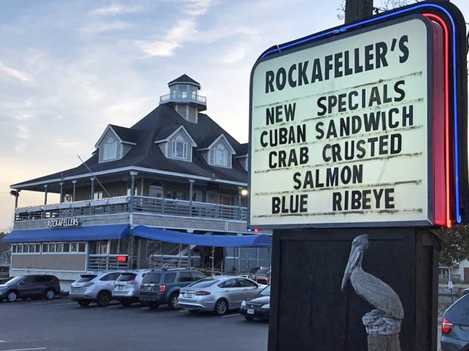 The roadside sign announces daily specials like a town crier, while the restaurant stands proudly in the background—a lighthouse for hungry travelers.