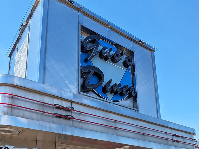 The neon sign glows like a beacon for hungry travelers. More than letters—it's a promise of comfort food that will hug your insides like a warm blanket.