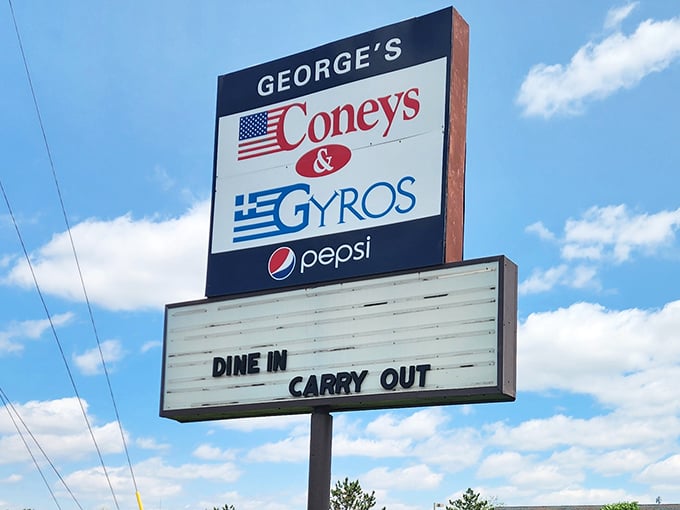 The roadside sign proudly flying both American and Greek flags—a perfect symbol of the cultural fusion that makes this food so irresistibly special.