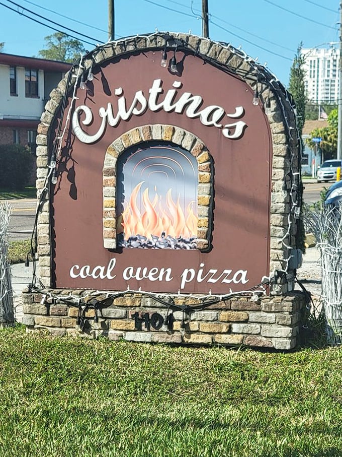 That iconic sign says it all—coal-fired pizza awaits. Like a beacon to the pizza-obsessed, it promises fiery deliciousness just steps away.