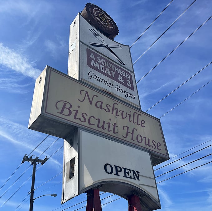 Not all heroes wear capes—some hang from poles announcing "OPEN" to hungry travelers seeking Southern comfort on a plate.