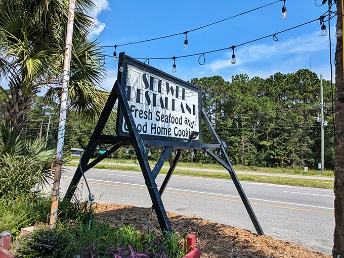 The roadside sign stands as a beacon for hungry travelers. Those string lights aren't just decoration—they're a signal that you've found your way home.