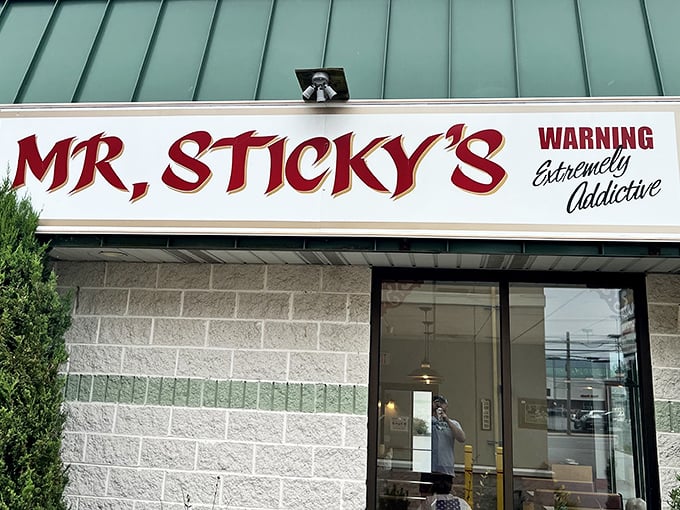 The sign that stops traffic and starts cravings. Like a lighthouse beacon guiding sugar-seekers safely to shore.
